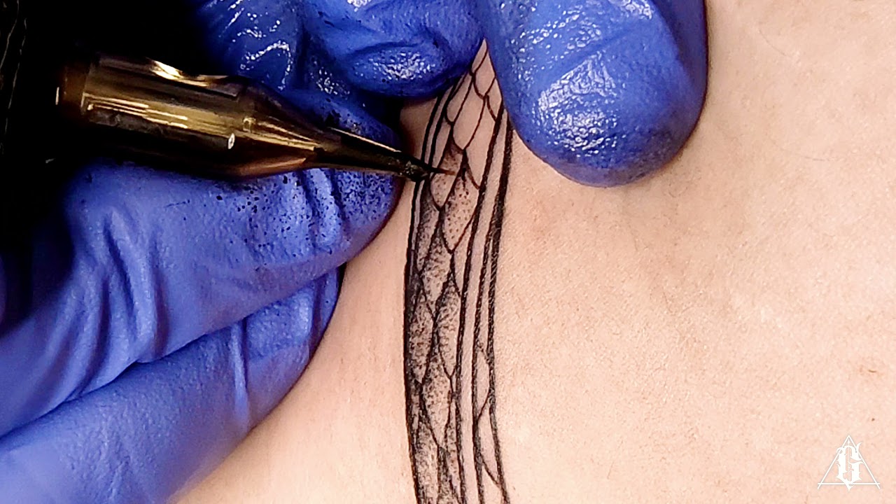 Close up Ouroboros arm band tattoo