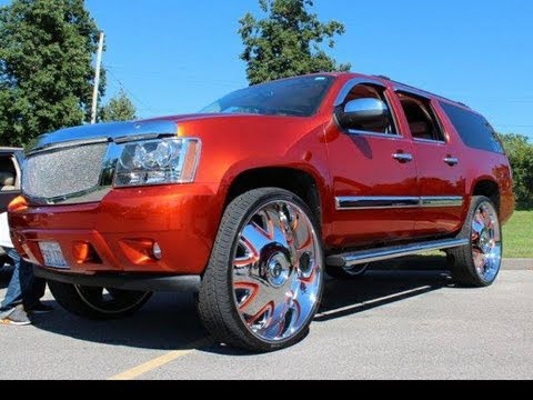 Kandy orange Suburban sitting tall on 32" DUB Bandito wheels