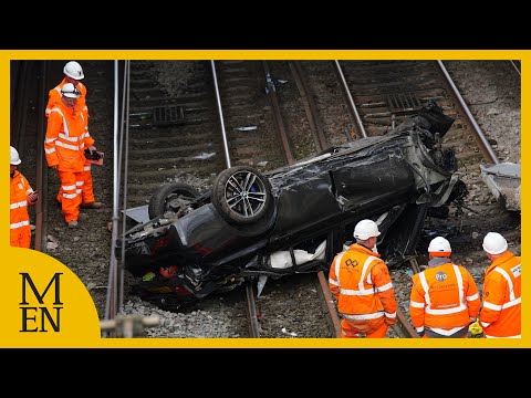LIVE: Car crashes at roundabout onto railway tracks with train travel ...