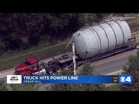 Oversized truck hits power lines, knocks out power