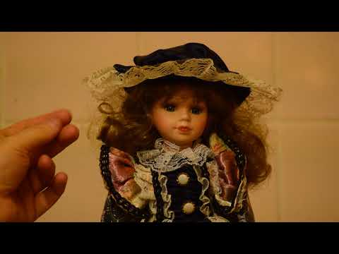 Porcelain doll! Bushy red haired with a pretty pattern clothing.
