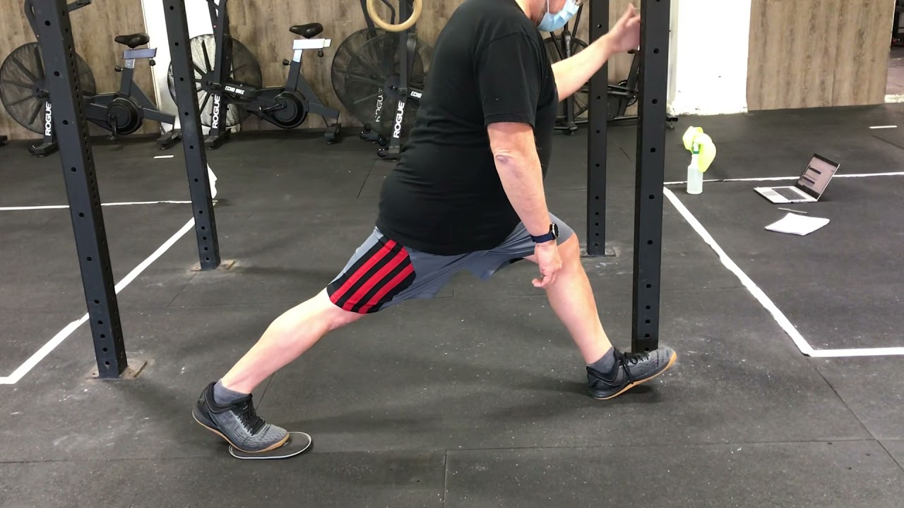 Standing eccentric hamstring with slider