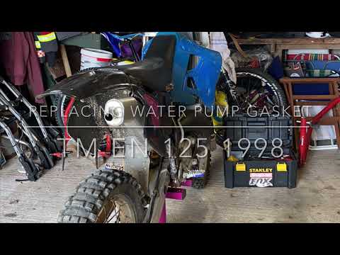 Female Mechanic Replacing The Water Pump Gasket on a 1998 TM EN125