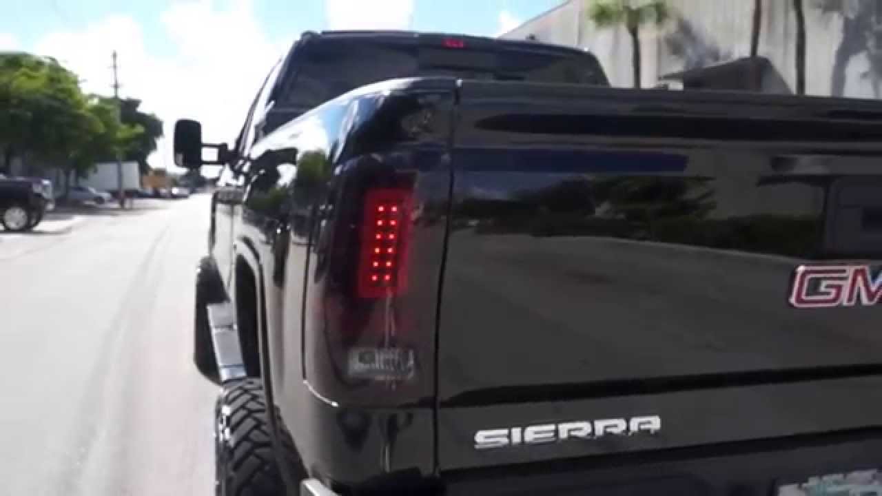 RECON Part # 264239RBK Red Smoked LED Tail Lights installed on a Black 2015 GMC Sierra HD