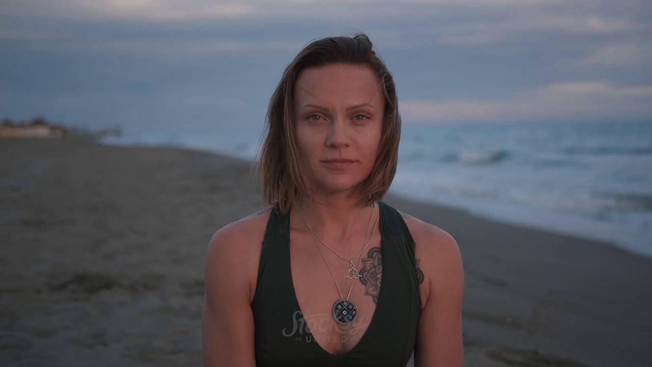 Woman practice yoga on the beach in the sunset. (Stocksy United)