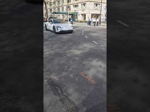 White Sports Car Passing By On 5th Ave In Manhattan, New York City