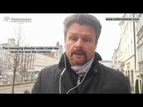 What is the difference between director under commercial law and under trade law in a Austrian GmbH