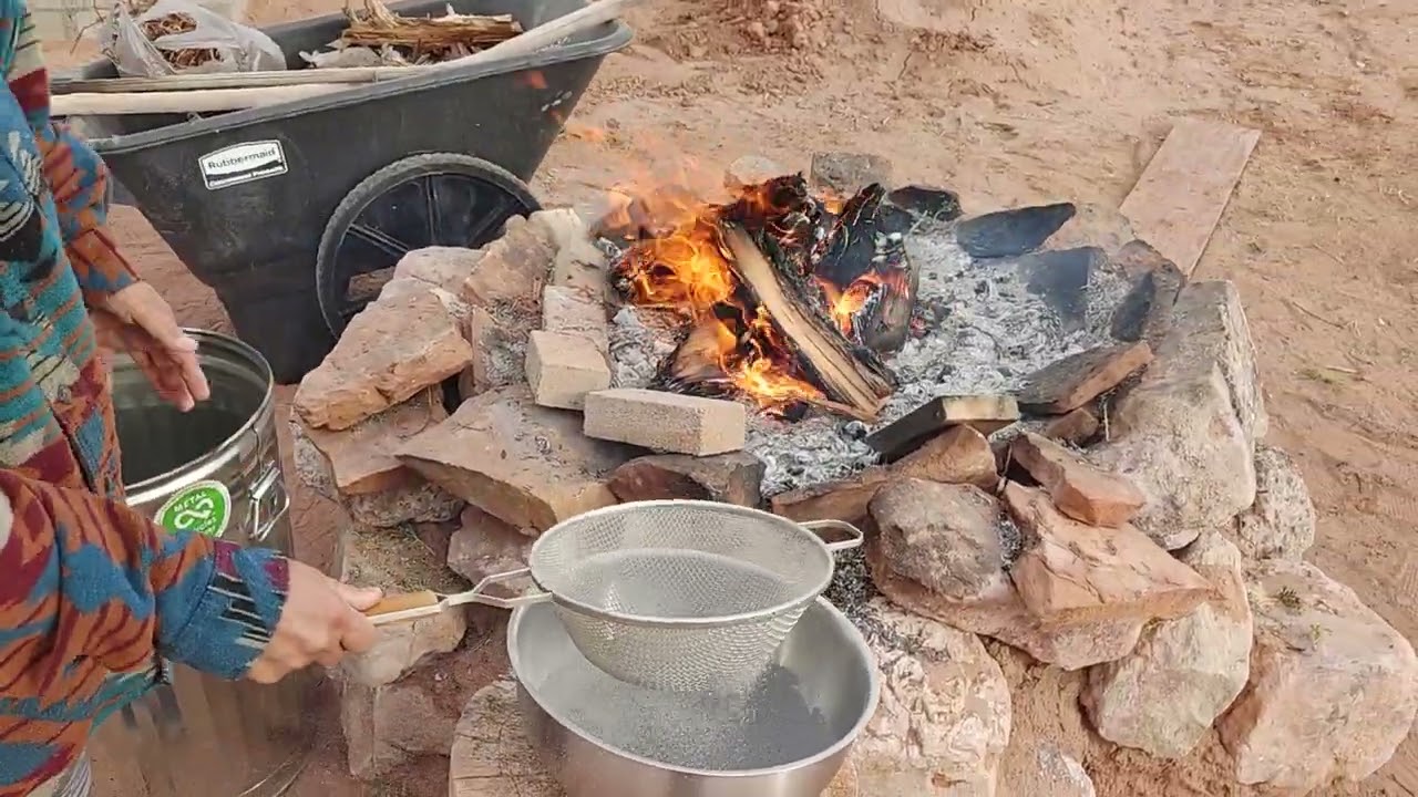 sifting the Juniper ash for cooking use.