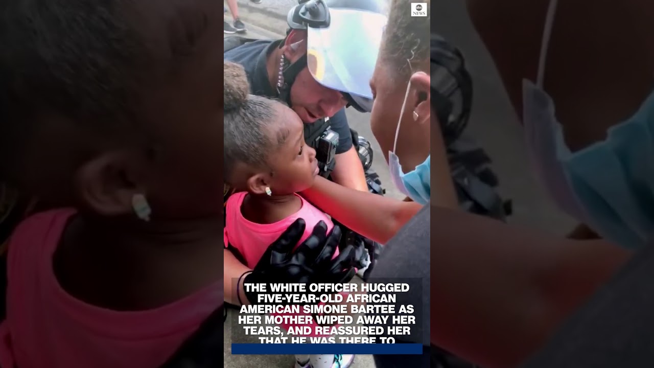 Police officer comforts 5-year-old girl at George Floyd protest