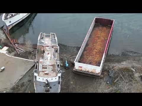 Deep Water Recovery working on bringing another barge up ...