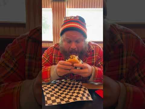 Hey Man eats a Filet-o-burger sandwich at Hill Street in Fish Creek, WI