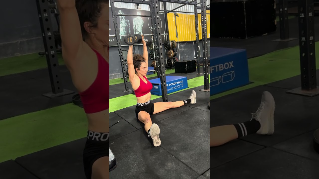 Straddle seated dual dumbbell press