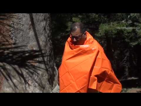 Using an emergency blanket for shelter