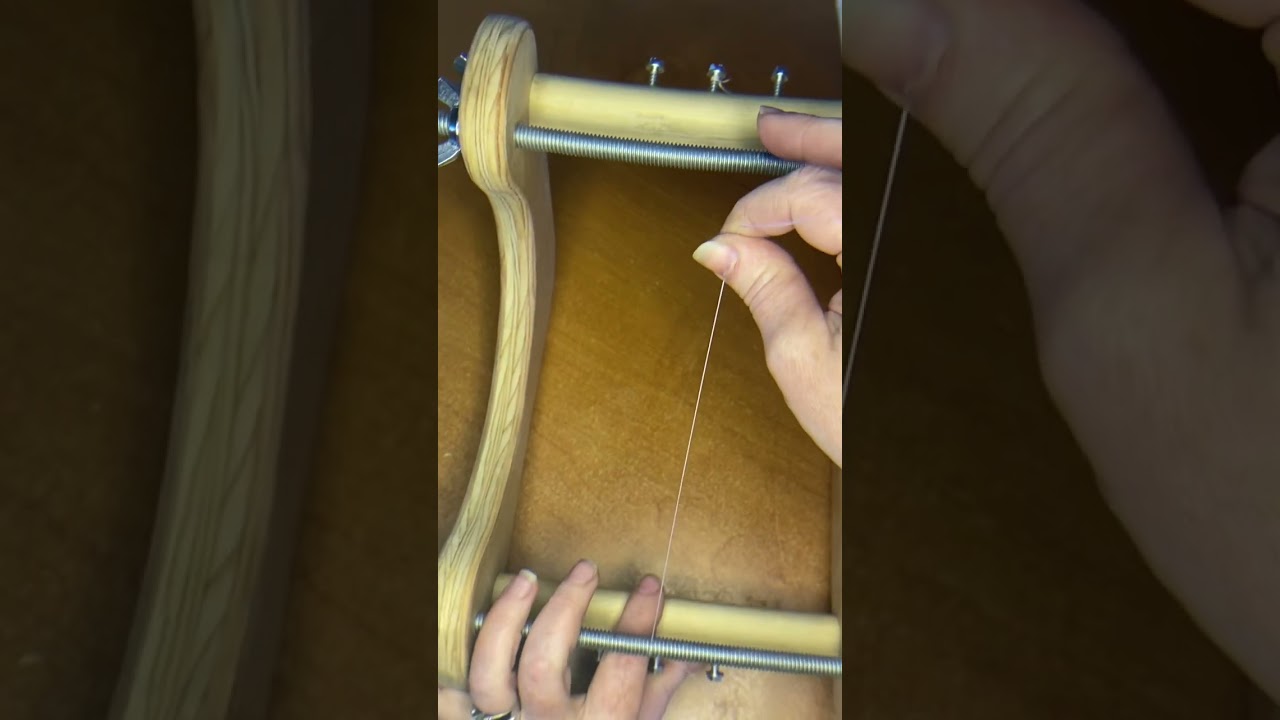 Adding warp thread to an upright bead loom
