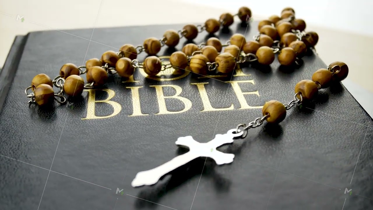 Holy Bible wiht rosary beads with cross crucifix