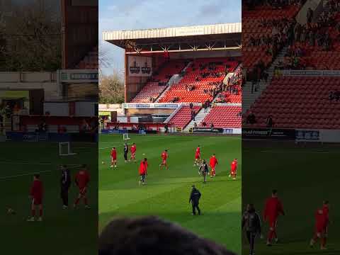 Swindon town fc players clapping the fans after warming up
