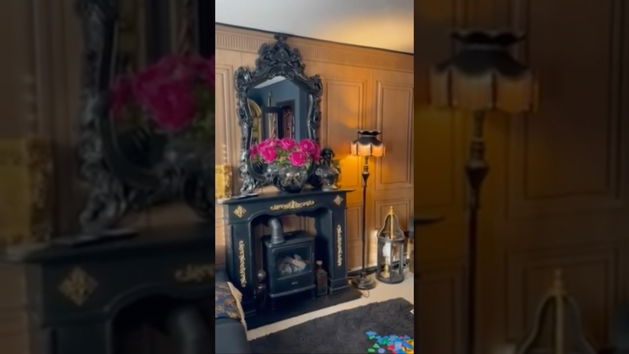 Gothic living room decor by day and by night 🖤 Love this fireplace with panel wallpaper! #interiors