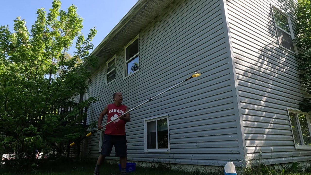 Using a Wagner multi-purpose cleaning kit to clean exterior second story windows
