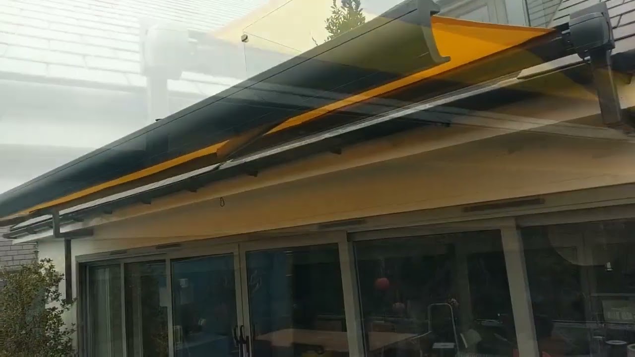 Markilux MX-3 motorised patio awning fitted using custom designed gutter brackets